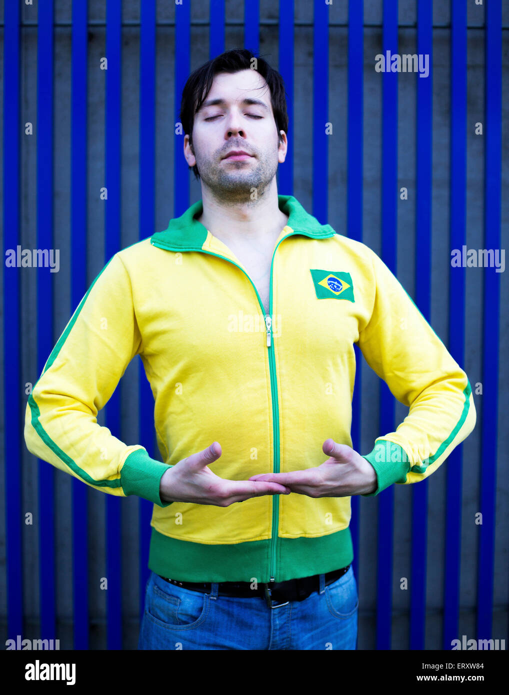 man in yellow jacket pretends to meditate Stock Photo - Alamy