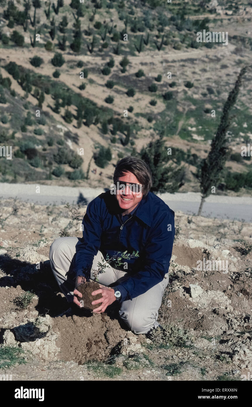 A visitor to Israel shows off the tiny tree he purchased and is ready ...