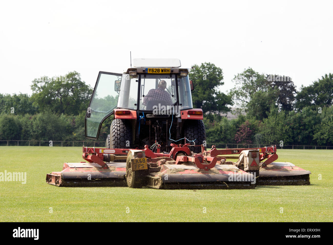 A tractor mowing a polo field Stock Photo - Alamy