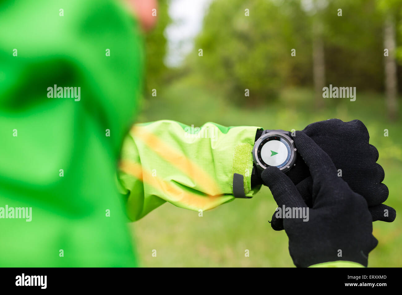 Hiker looking at electronic compass, sport gps smart watch. Man ...
