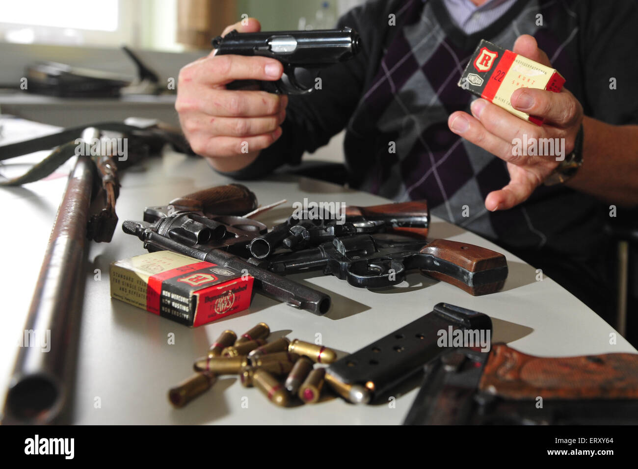 Police inspecting weapons confiscated during raid Stock Photo - Alamy