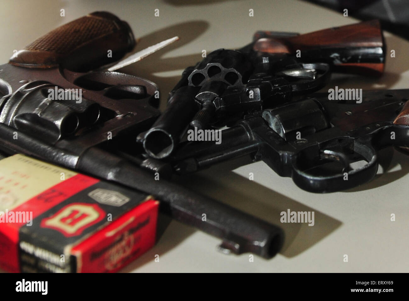 Police inspecting weapons confiscated during raid Stock Photo - Alamy