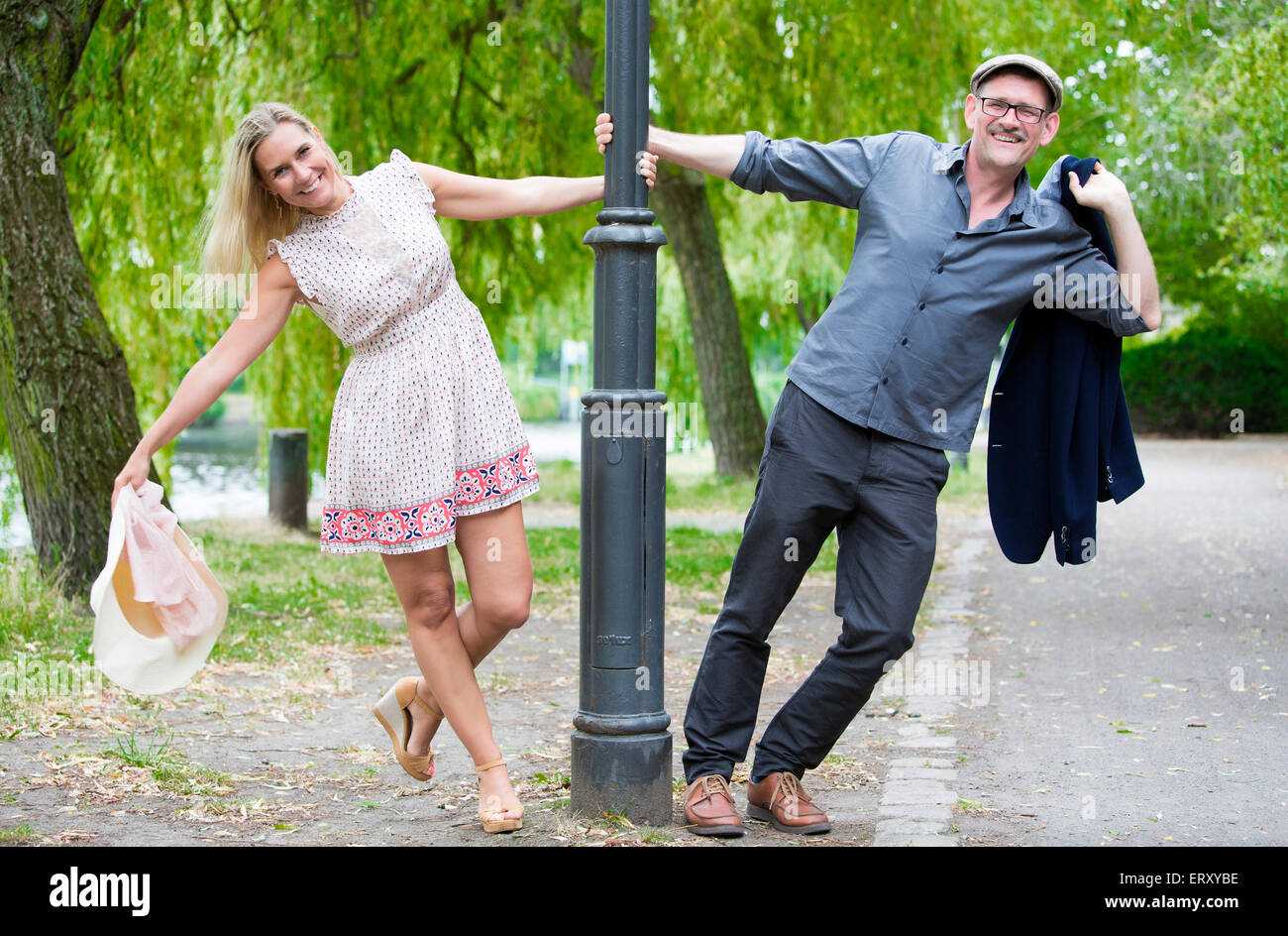 Woman holding onto man hi-res stock photography and images - Alamy