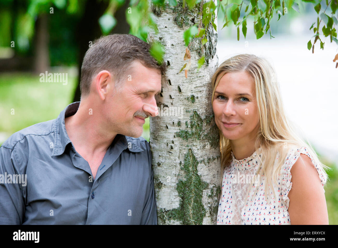 Couple standing in park hi-res stock photography and images - Alamy