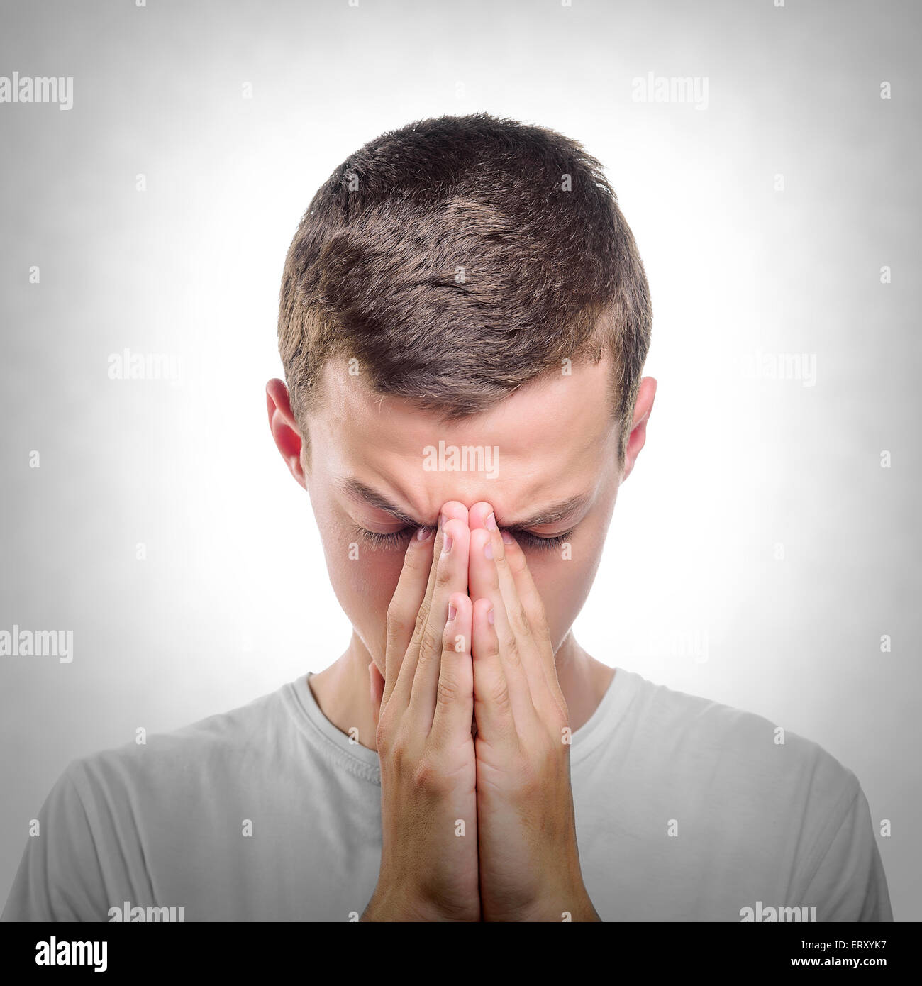 Young man praying or thinking Stock Photo - Alamy