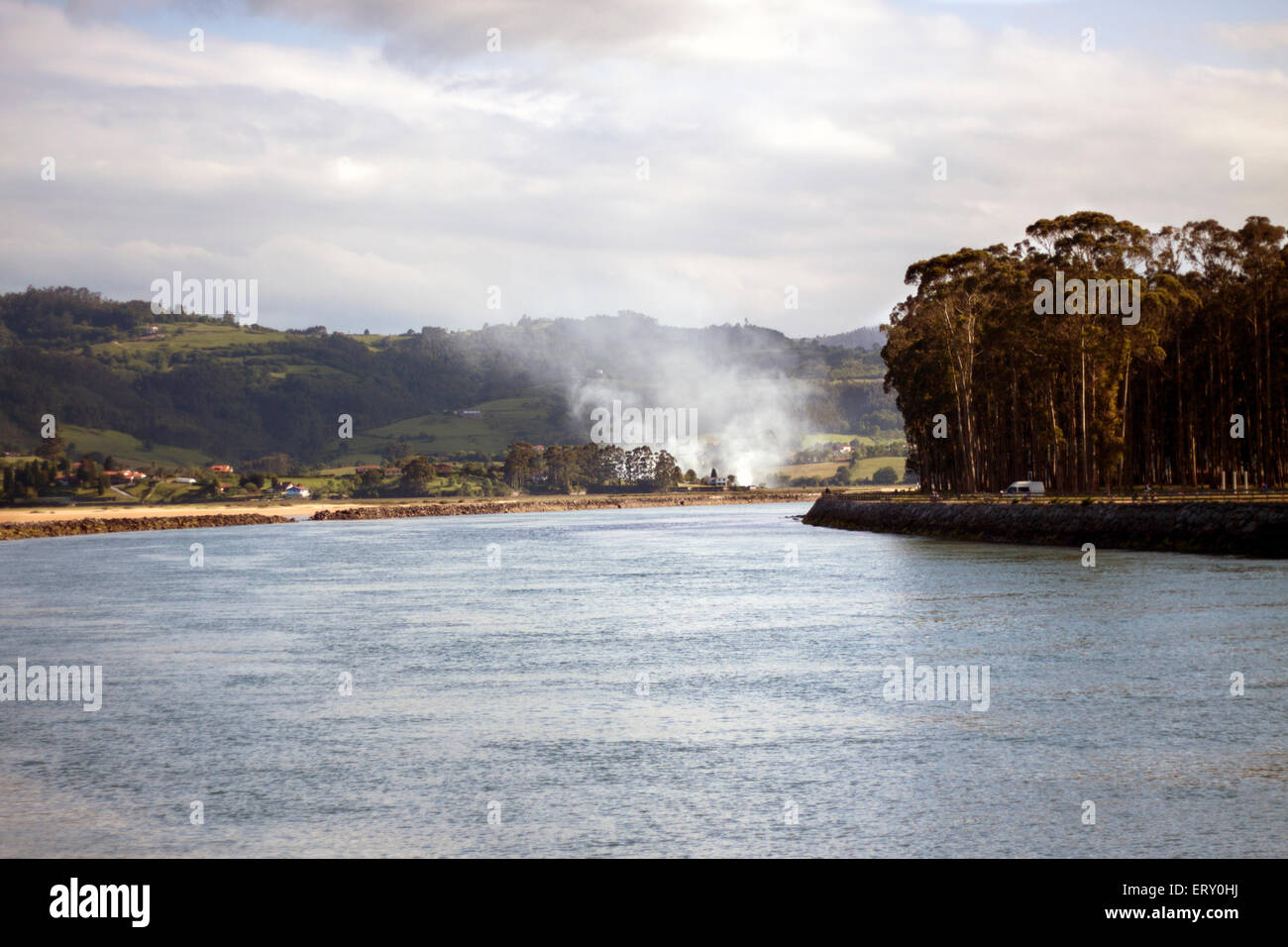 a landscape with smoke in a magnificent scenery of a estuary Stock ...