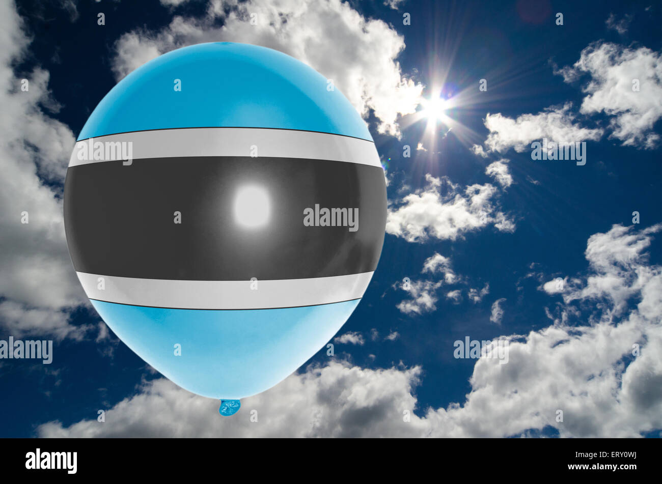 balloon in colors of botswana flag flying on blue sky Stock Photo - Alamy