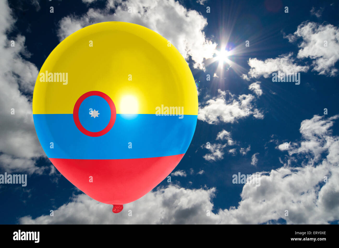 balloon in colors of colombia flag flying on blue sky Stock Photo - Alamy