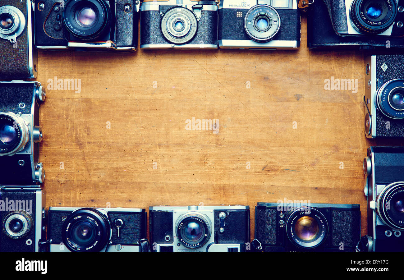 Old retro film analogue cameras collection on vintage wooden desk ...