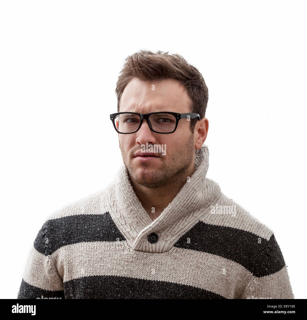 Portrait of a handsome young man with an angry expression, against a ...