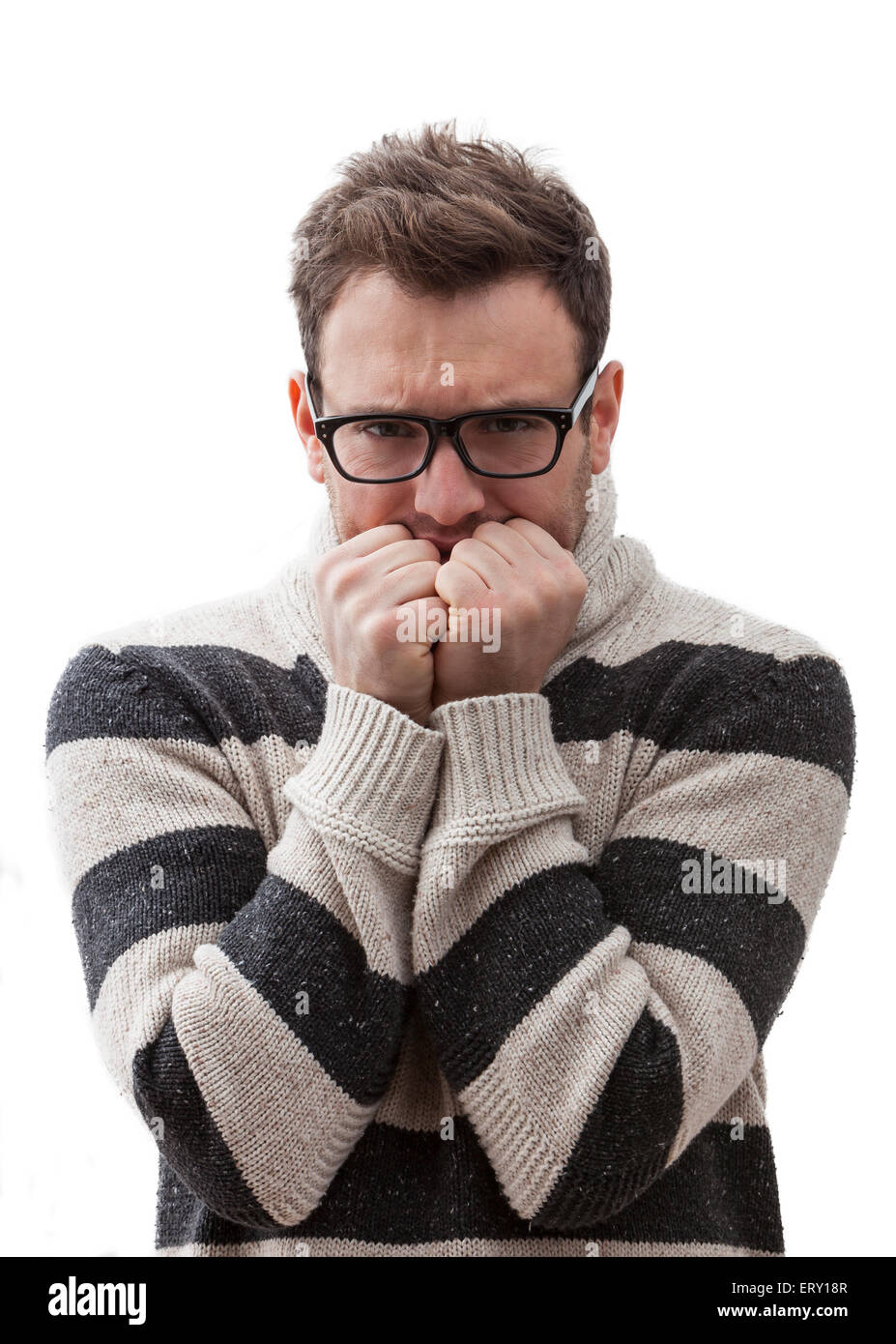 Portrait of a handsome young man with a terrified expression, against a ...