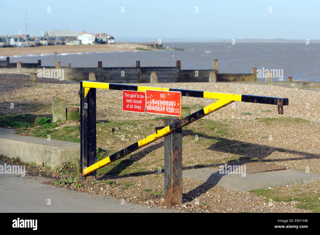 An open black and yellow gate with a sign saying 'This gate to be kept ...