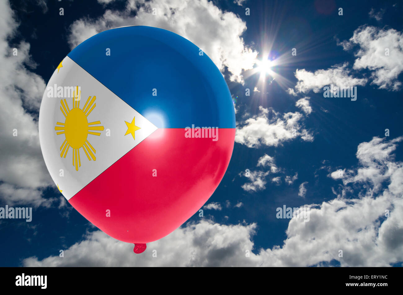 balloon in colors of philippines flag flying on blue sky Stock Photo ...