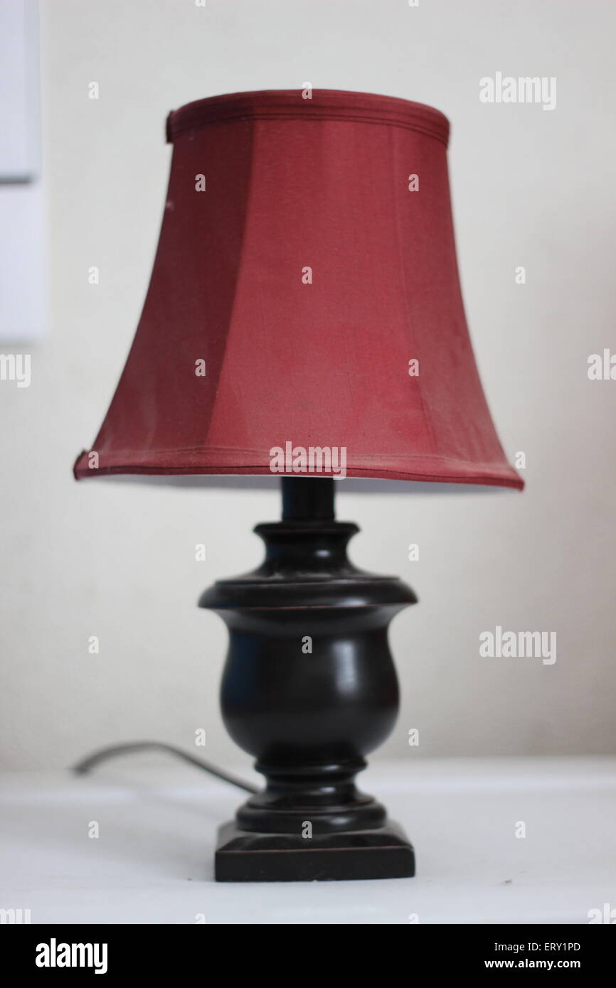 A dusty red lamp sits on a shelf Stock Photo - Alamy