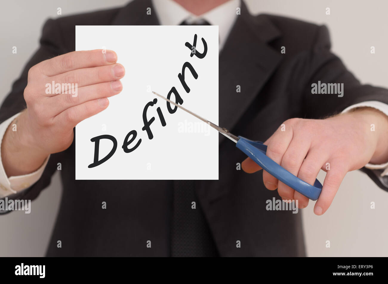 Defiant, man in suit cutting text on paper with scissors Stock Photo ...