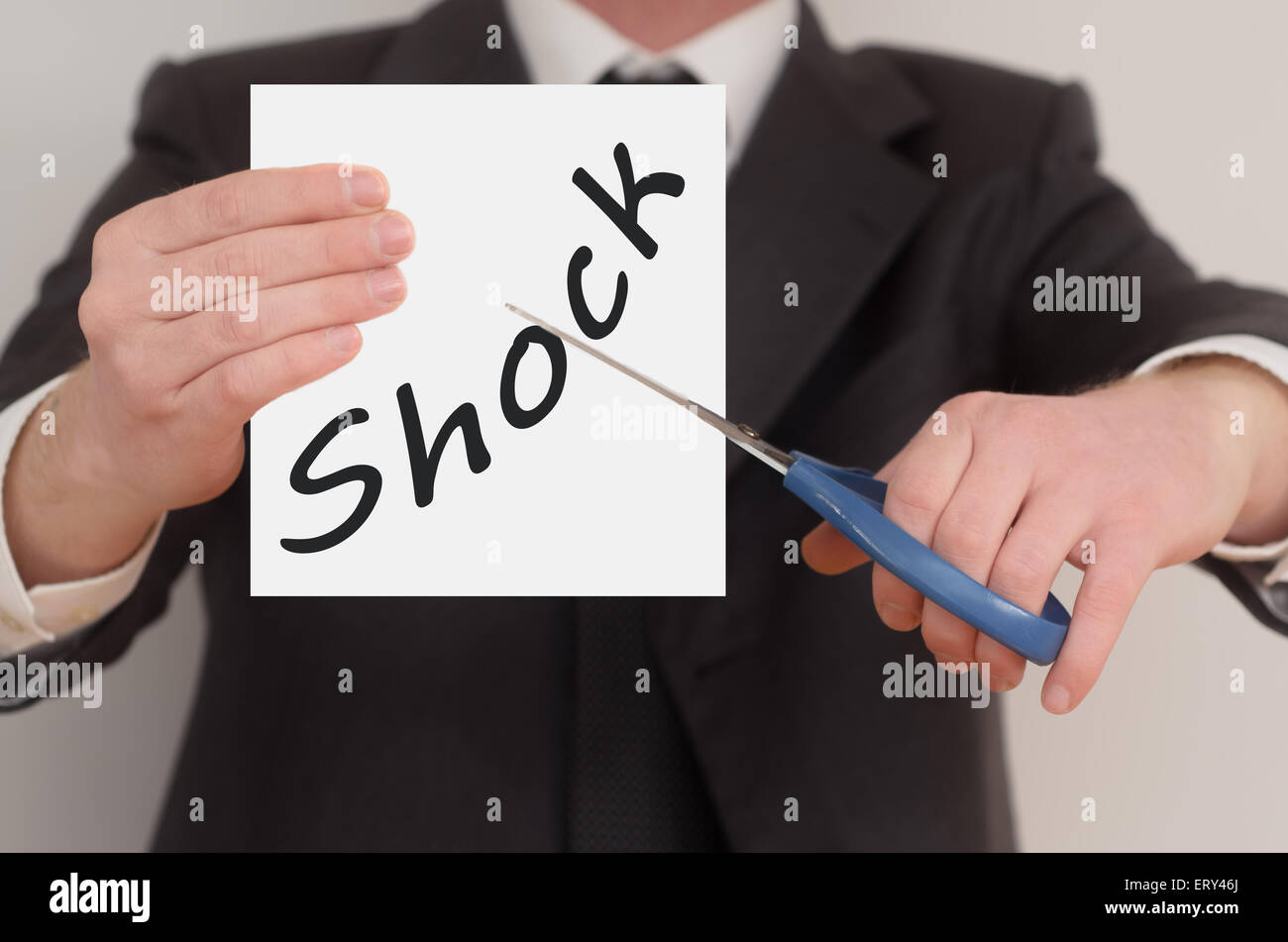 Shock, man in suit cutting text on paper with scissors Stock Photo - Alamy