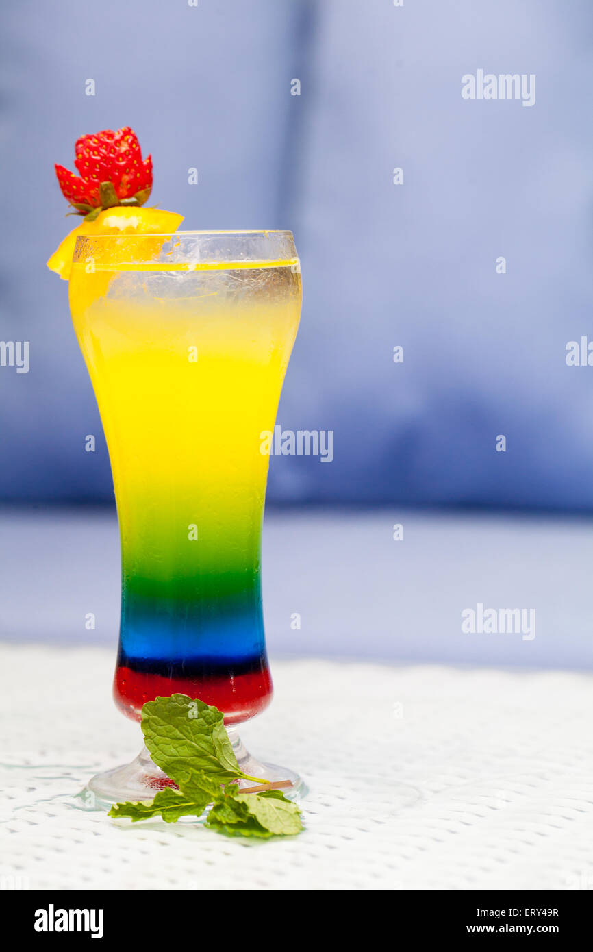 Rainbow fresh drink with blue background Stock Photo - Alamy
