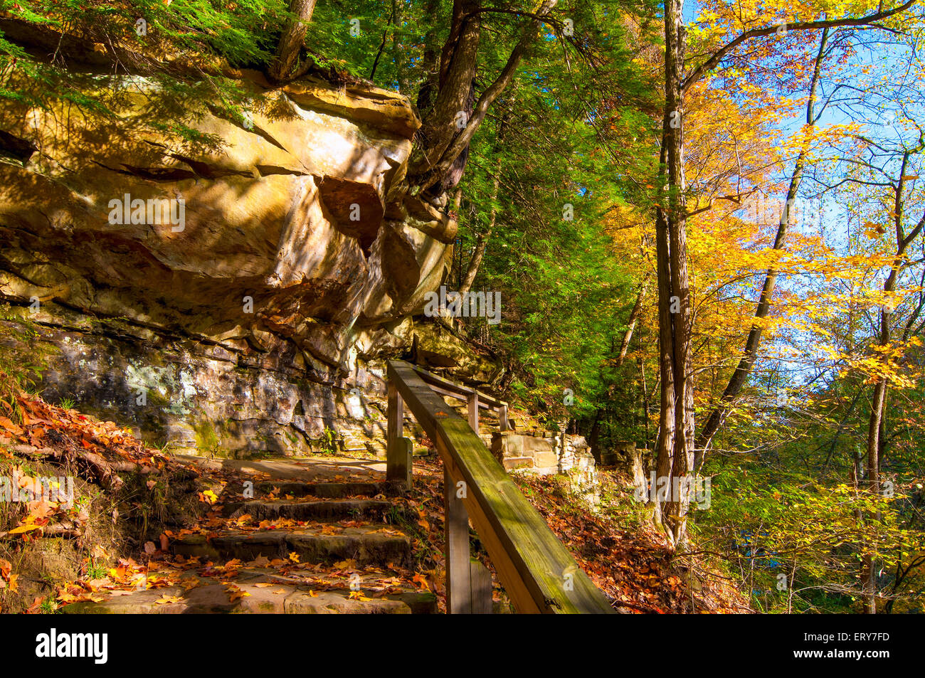 A trail above the Chagrin River near Cleveland Ohio passes under rock ...