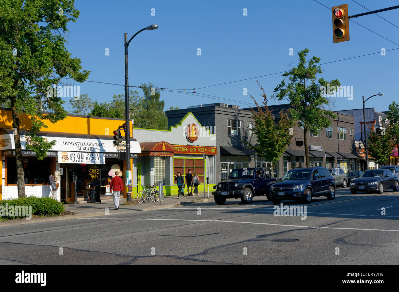 Vehicles stopped at a red traffic light on Main Street, Vancouver, BC ...
