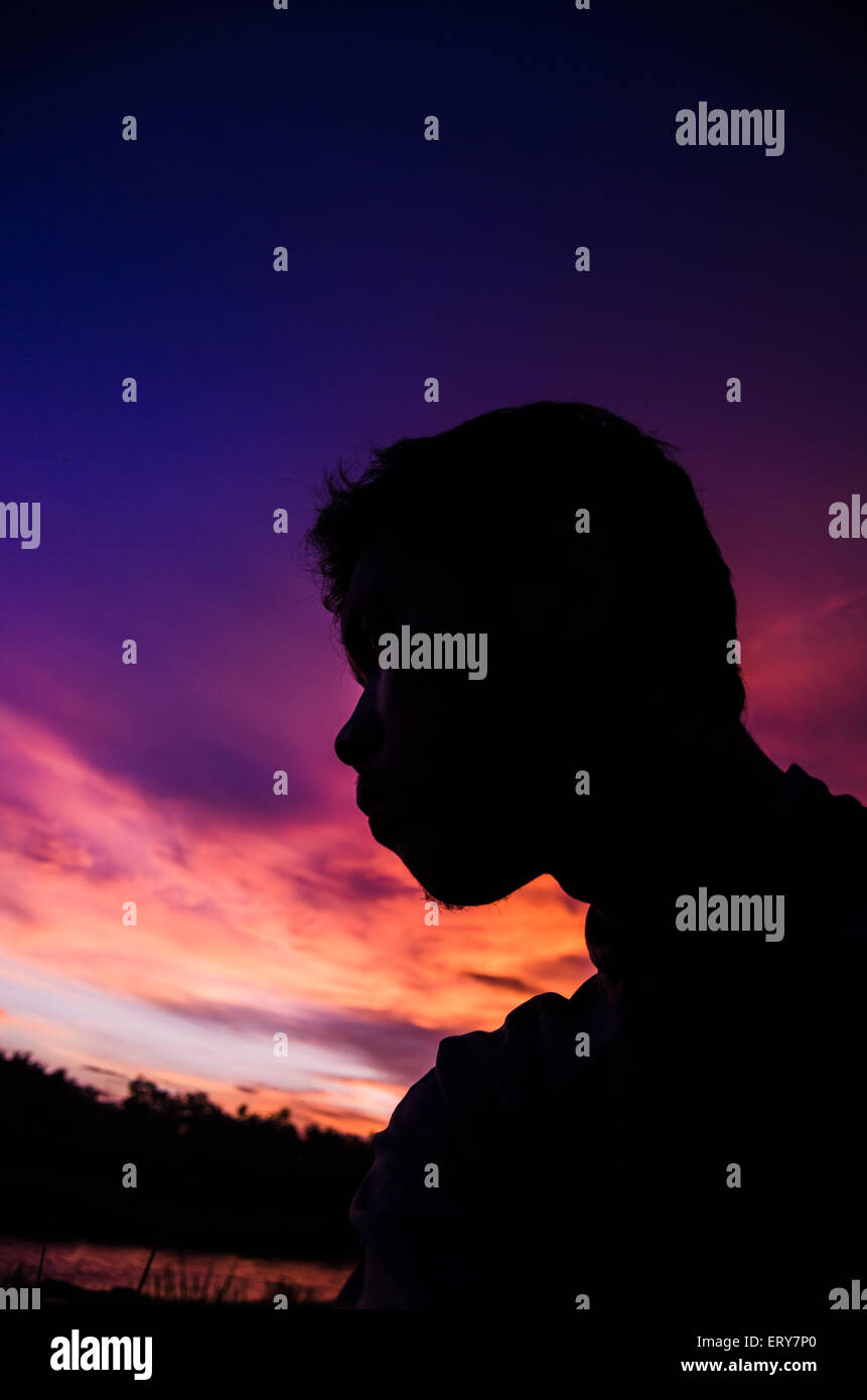the boy look at sunset Stock Photo - Alamy