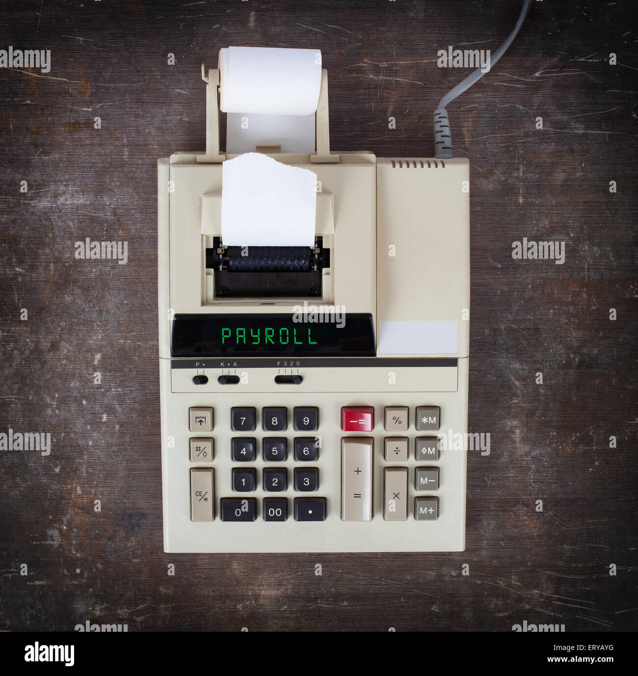 Old calculator showing a text on display - payroll Stock Photo - Alamy