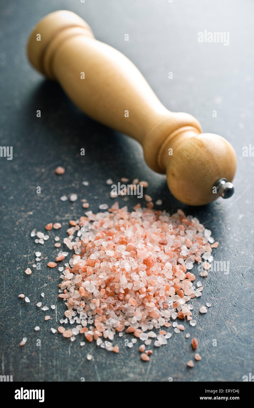 Himalayan salt and mill on old kitchen table Stock Photo - Alamy