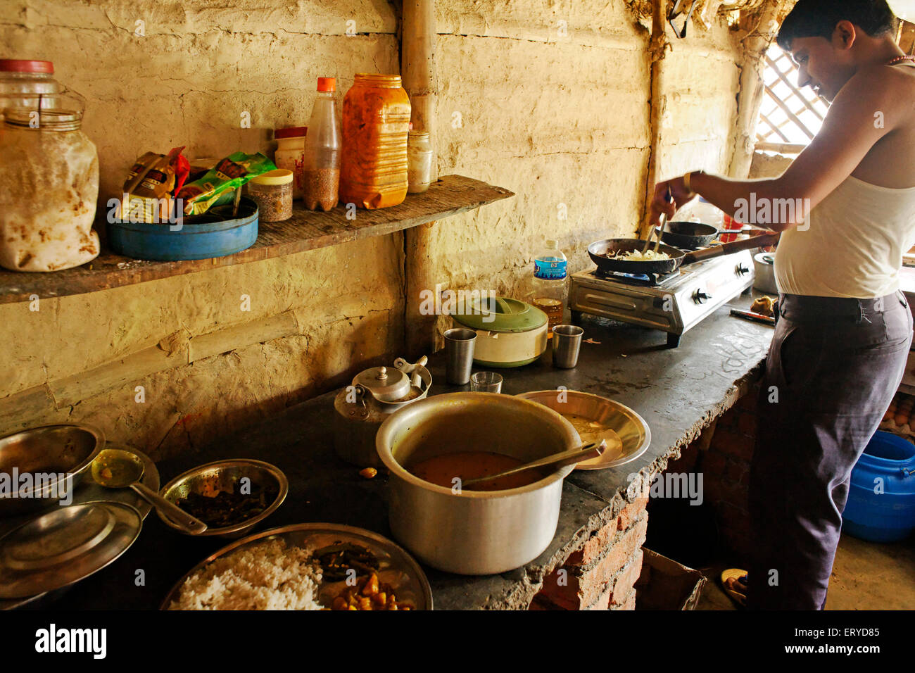 Man cooking vegetable noodles in Dhaba ; roadside restaurant , Lumbini ...