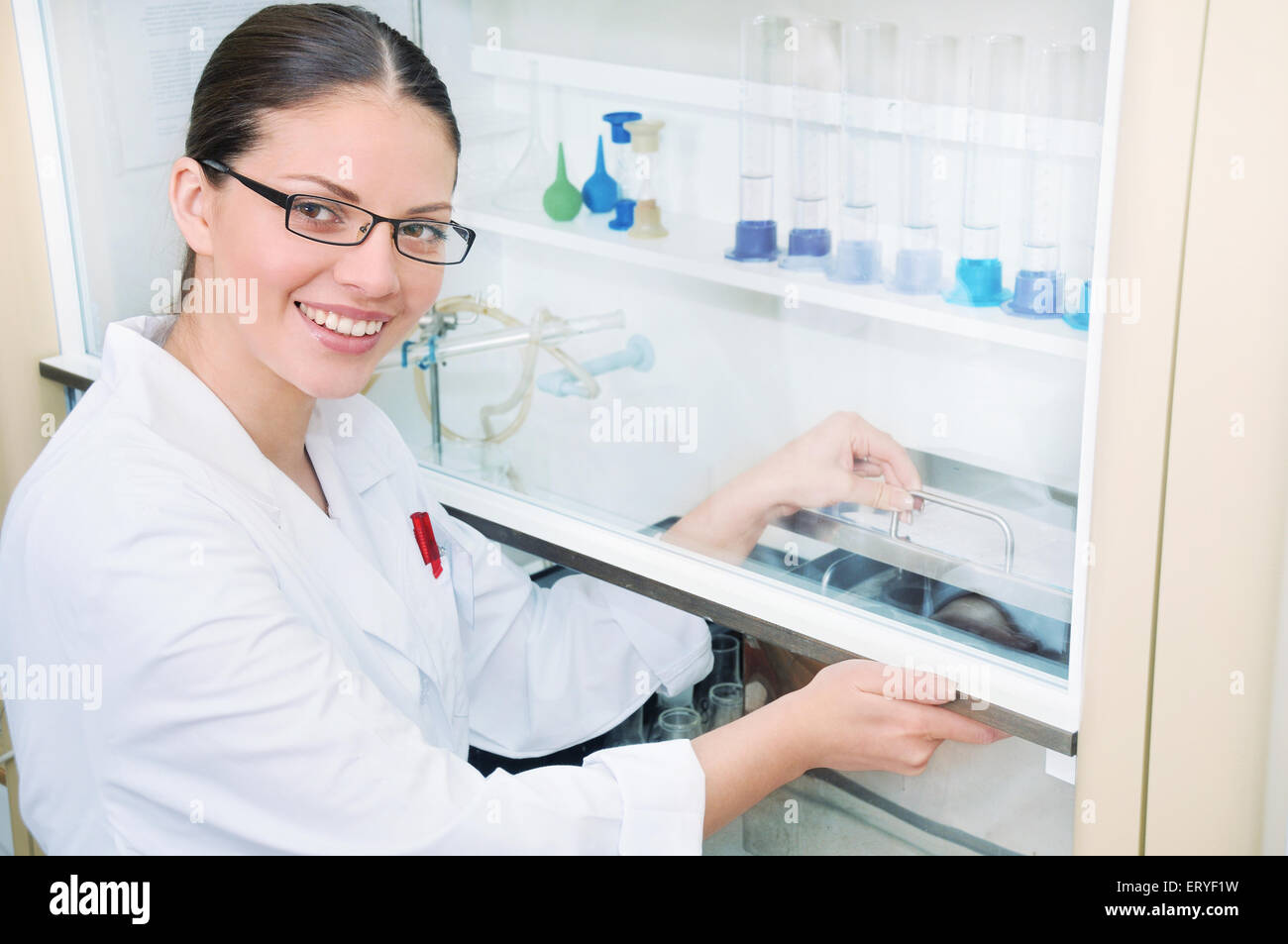 chemical laboratory scene: attractive young student scientist observing ...