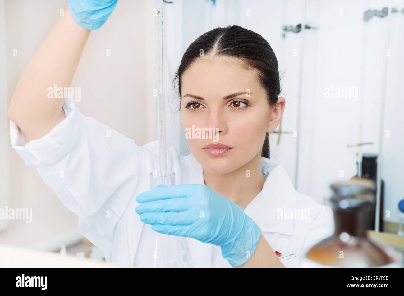chemical laboratory scene: attractive young student scientist observing ...