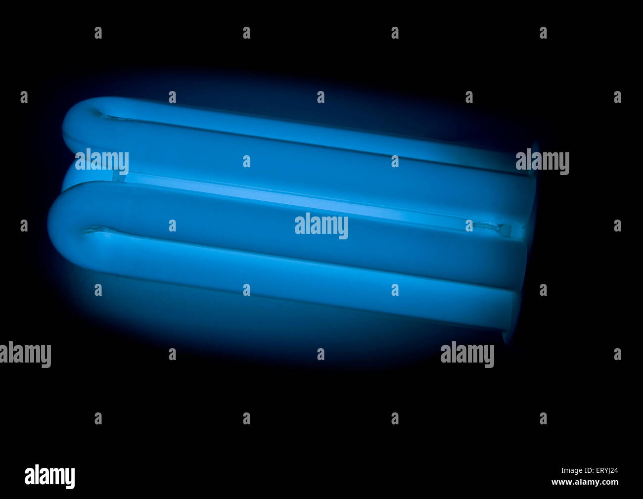 Energy saving lamp (lightbulb) with dark blue colour on the blac Stock ...