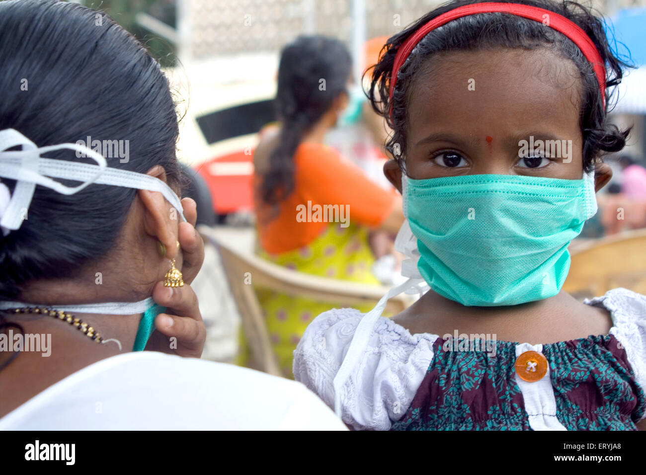 Mother and child wearing mask to avoid flu virus , Bombay , Mumbai ...