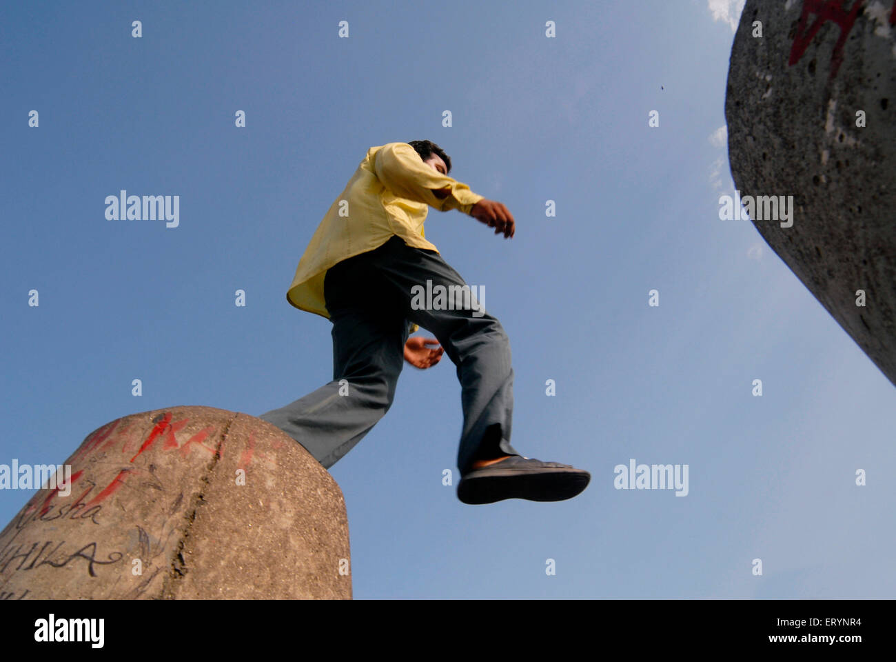 Man jump on a tetra pod to another at Marine Drive in Bombay Mumbai ...