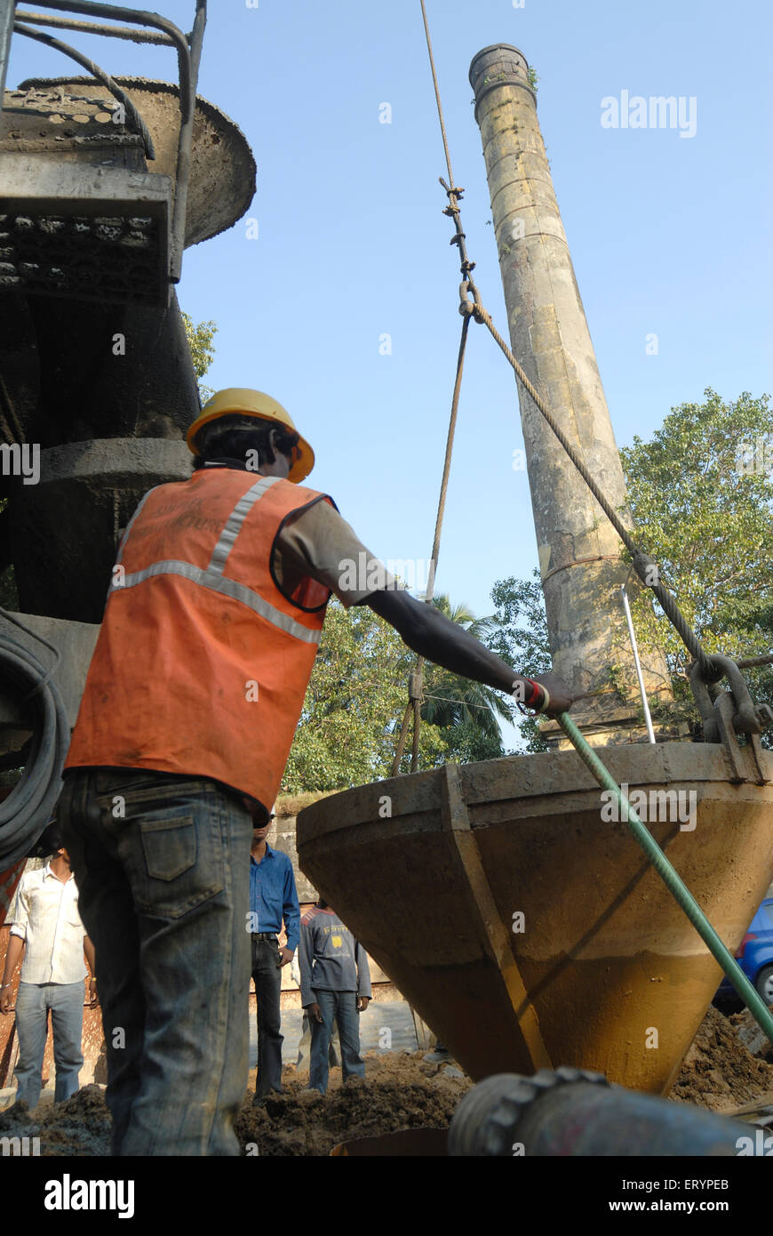 Workers fill concrete to erect pillar for 24 Km long Lalbaug flyover on ...