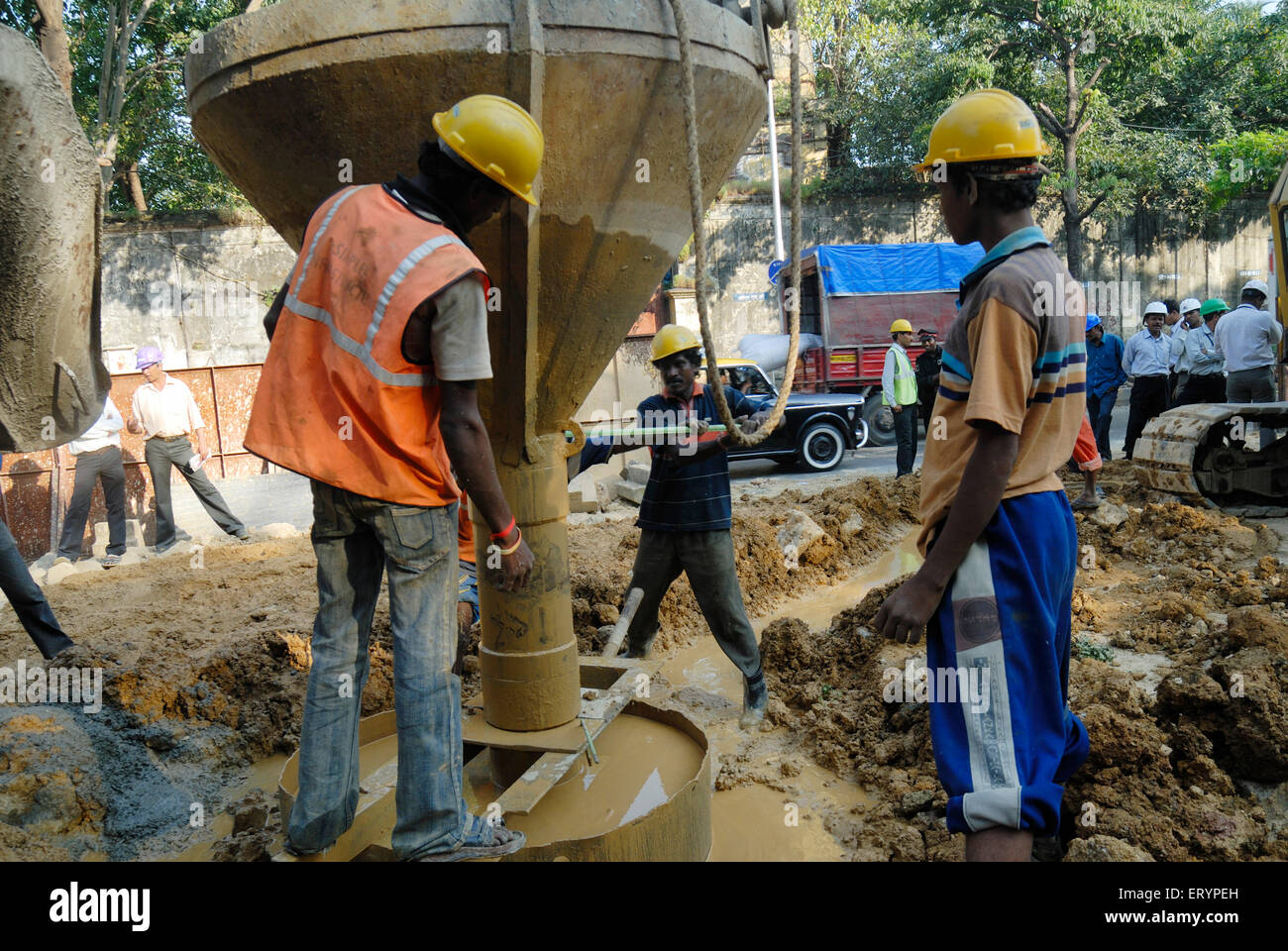 Workers fill concrete to erect pillar for 24 Km long Lalbaug flyover on ...