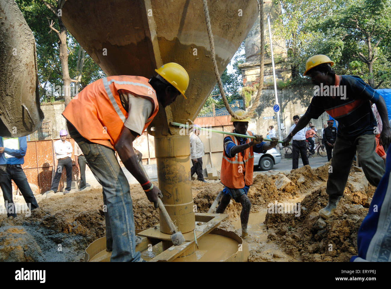 Workers fill concrete to erect pillar for 24 Km long Lalbaug flyover on ...