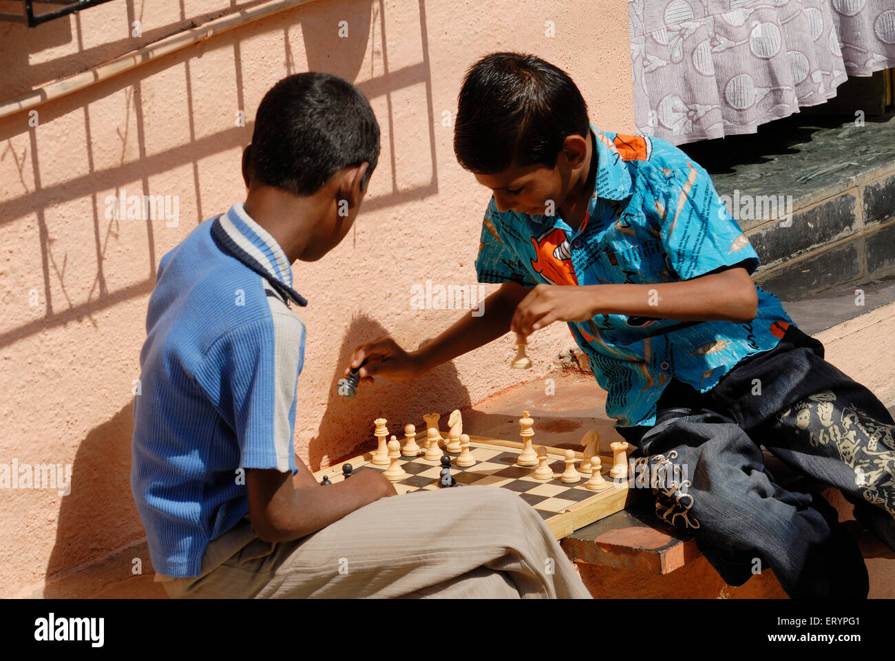 School children playing chess outside their homes in Bombay Mumbai ...