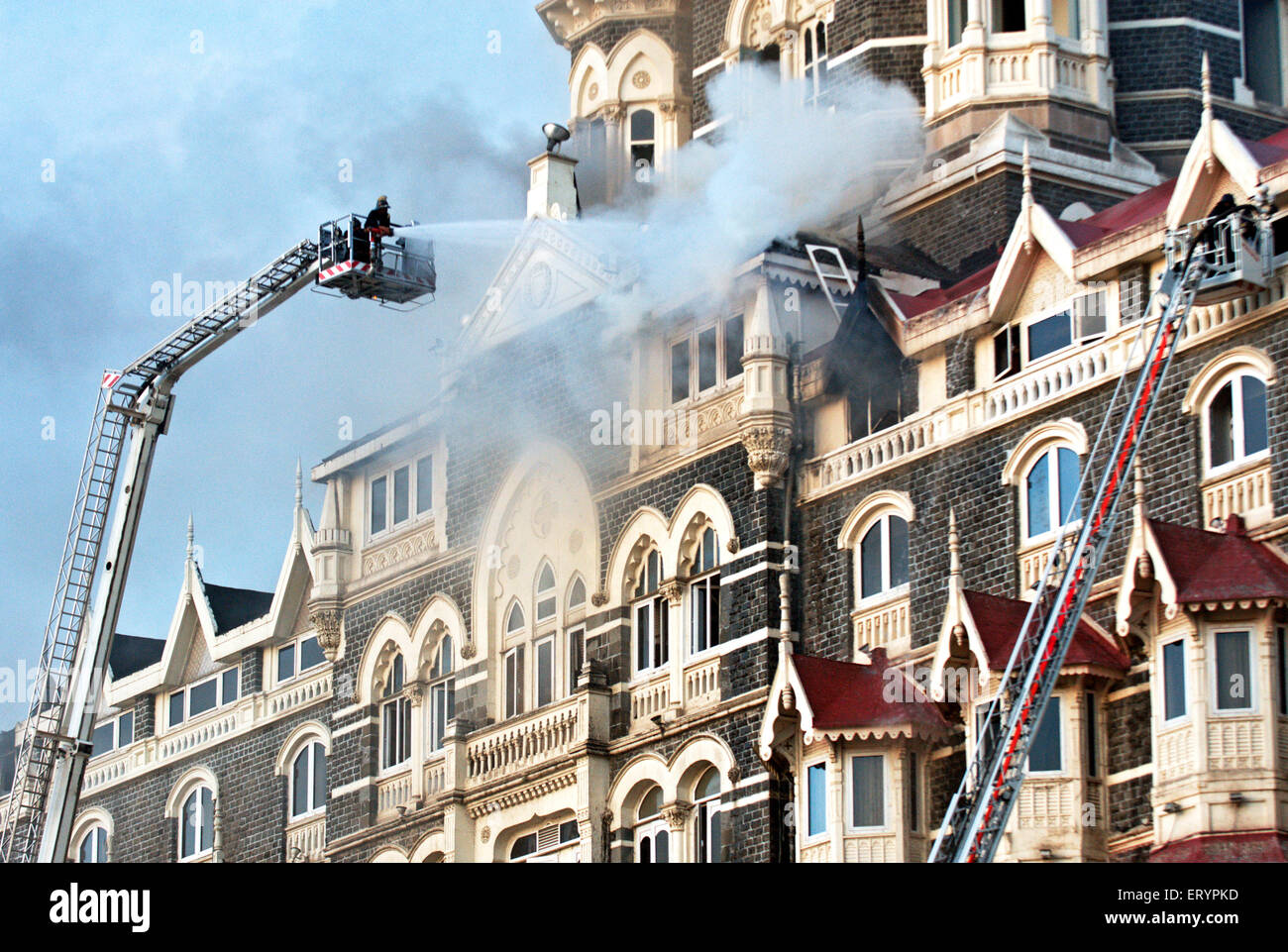 Fire fighters try to douse fire inside of Taj Mahal hotel after ...