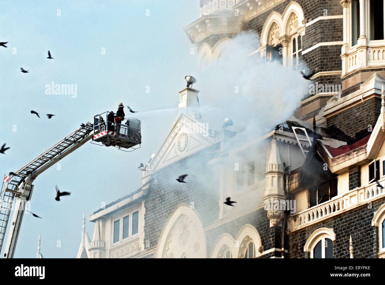 Fire fighters try to douse fire inside of Taj Mahal hotel after ...