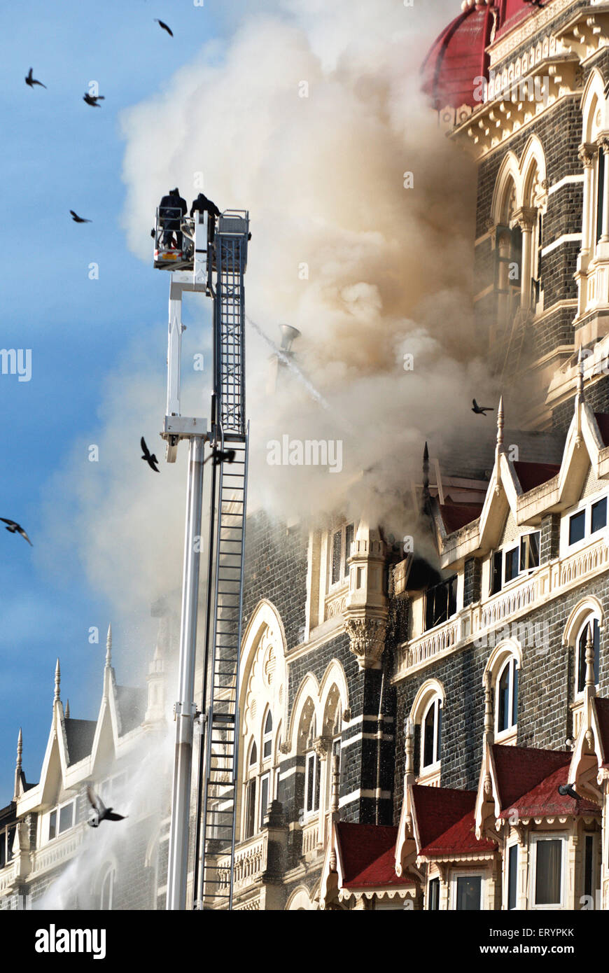 Fire fighters try to douse fire of Taj Mahal hotel terrorist attack by ...