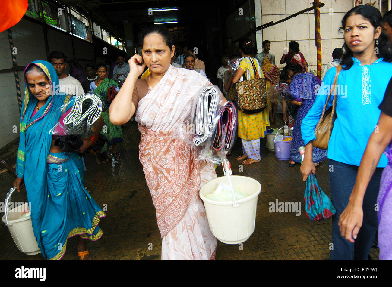 Poor people with relief materials, buckets, mats, food packets ...