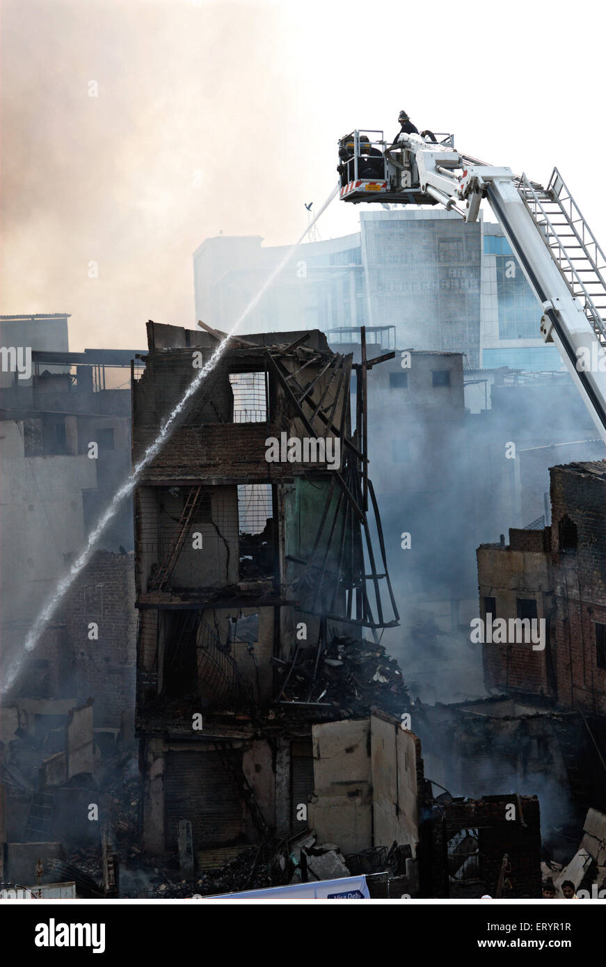 Firefighters dousing fire using snorkel in Behrampada slums ; Bandra ...