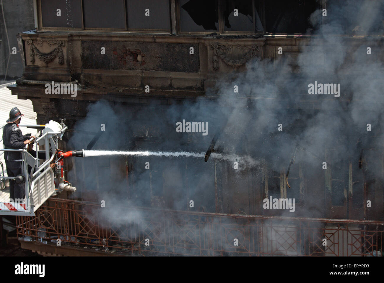 Firemen dousing fire in Johri Mansion at Kalbadevi ; Bombay Mumbai ...