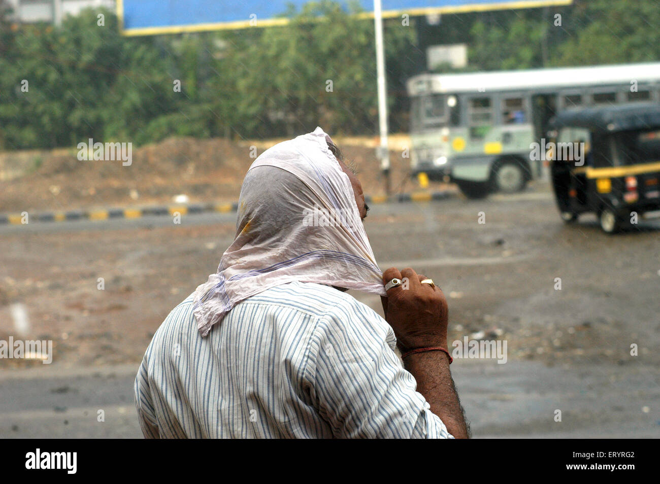 Man covering head with handkerchief in rain , Bombay , Mumbai ...