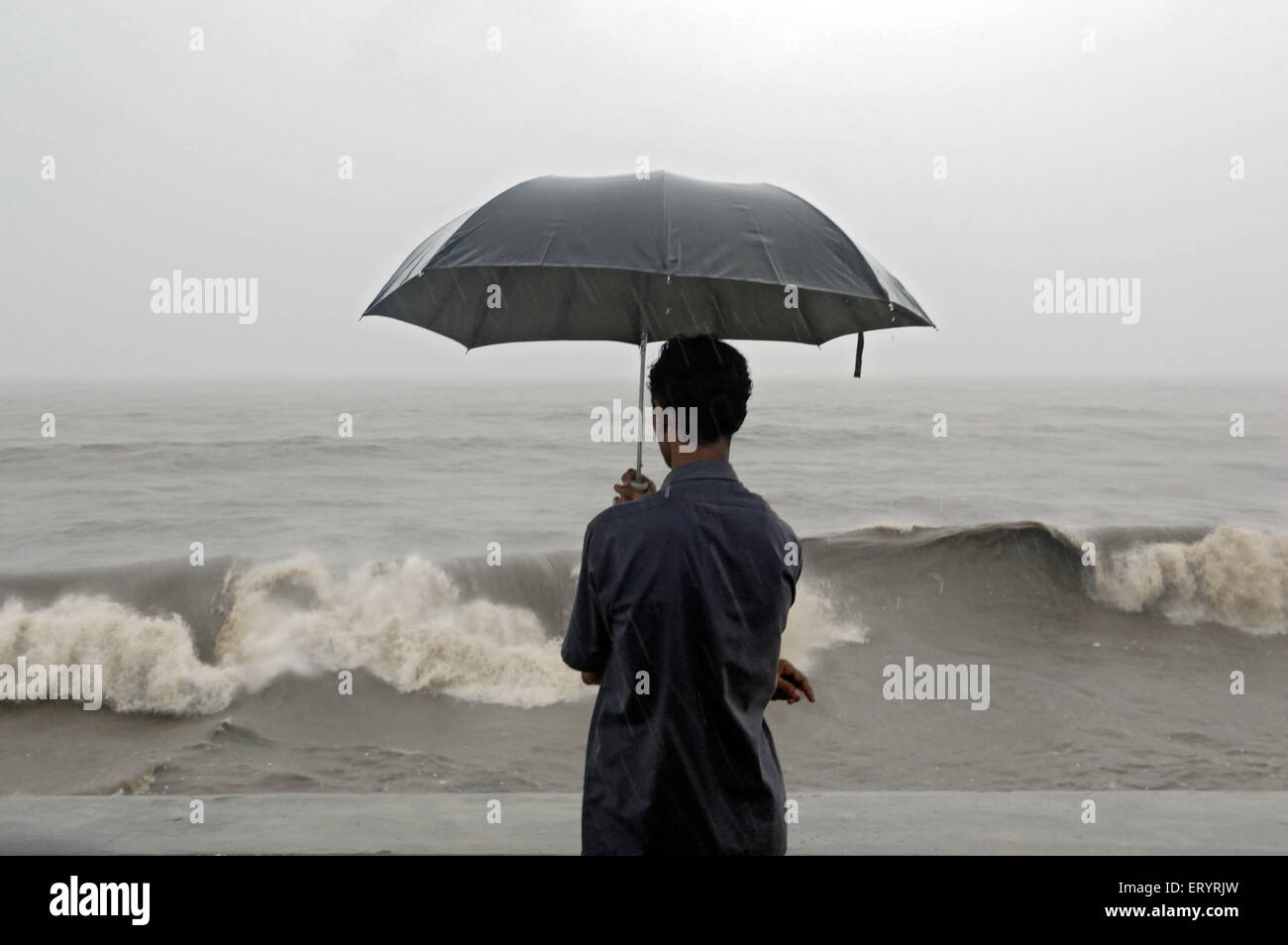 Man looking at sea , Worli ; Bombay , Mumbai ; Maharashtra ; India ...