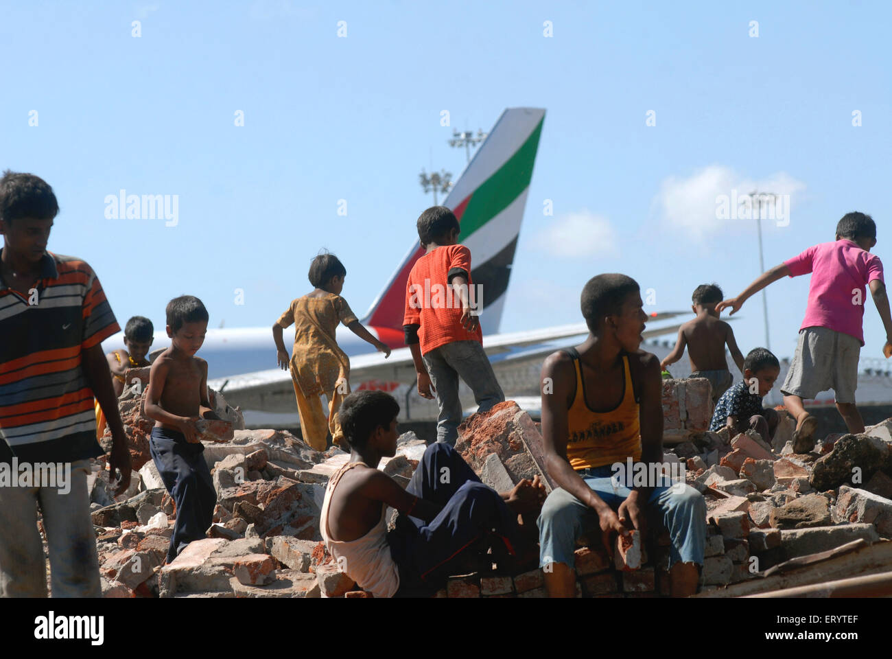 Slum dwellers sit with their belongings after demolition of slums on ...