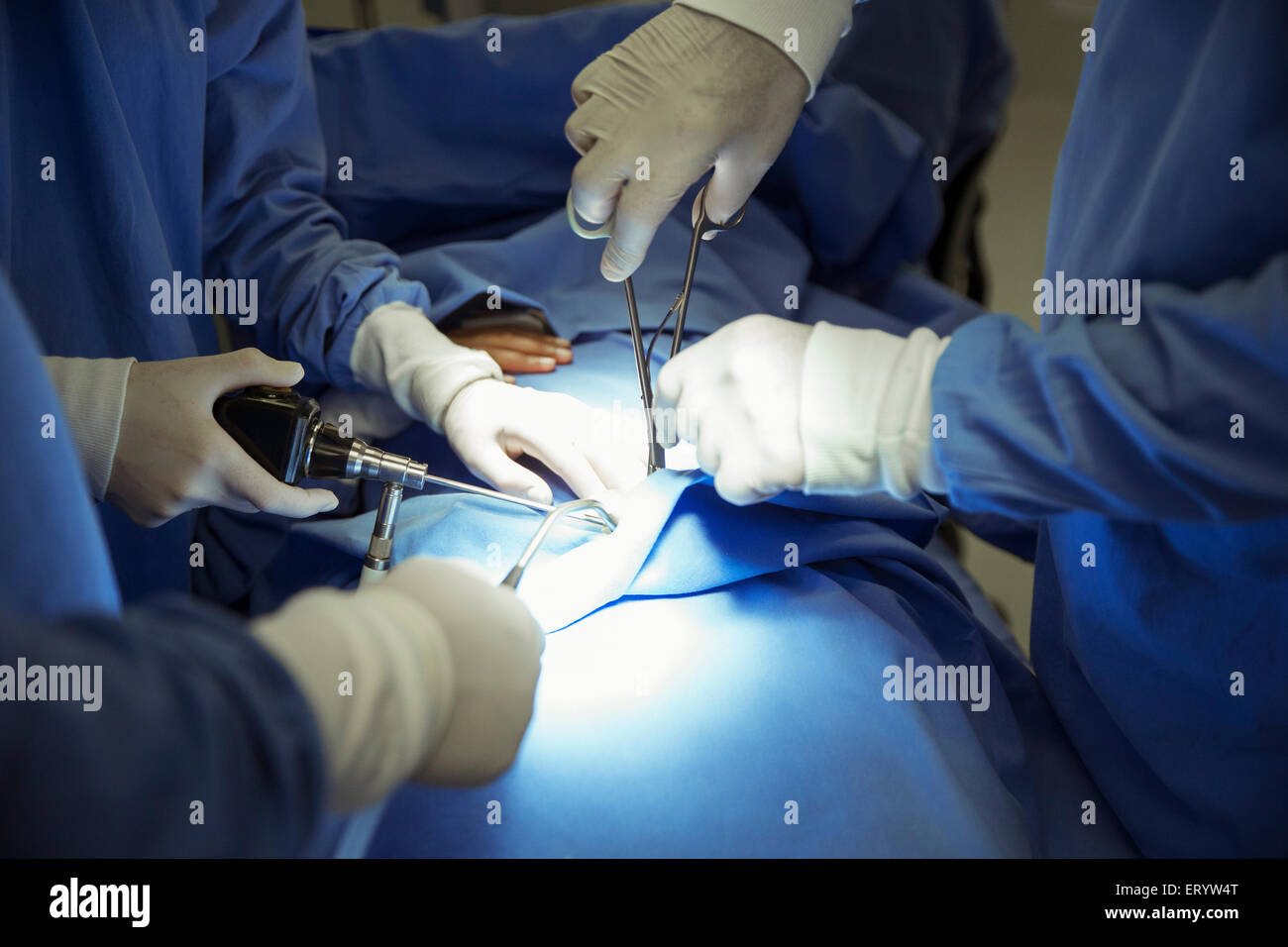 Surgeons performing surgery in operating room Stock Photo - Alamy