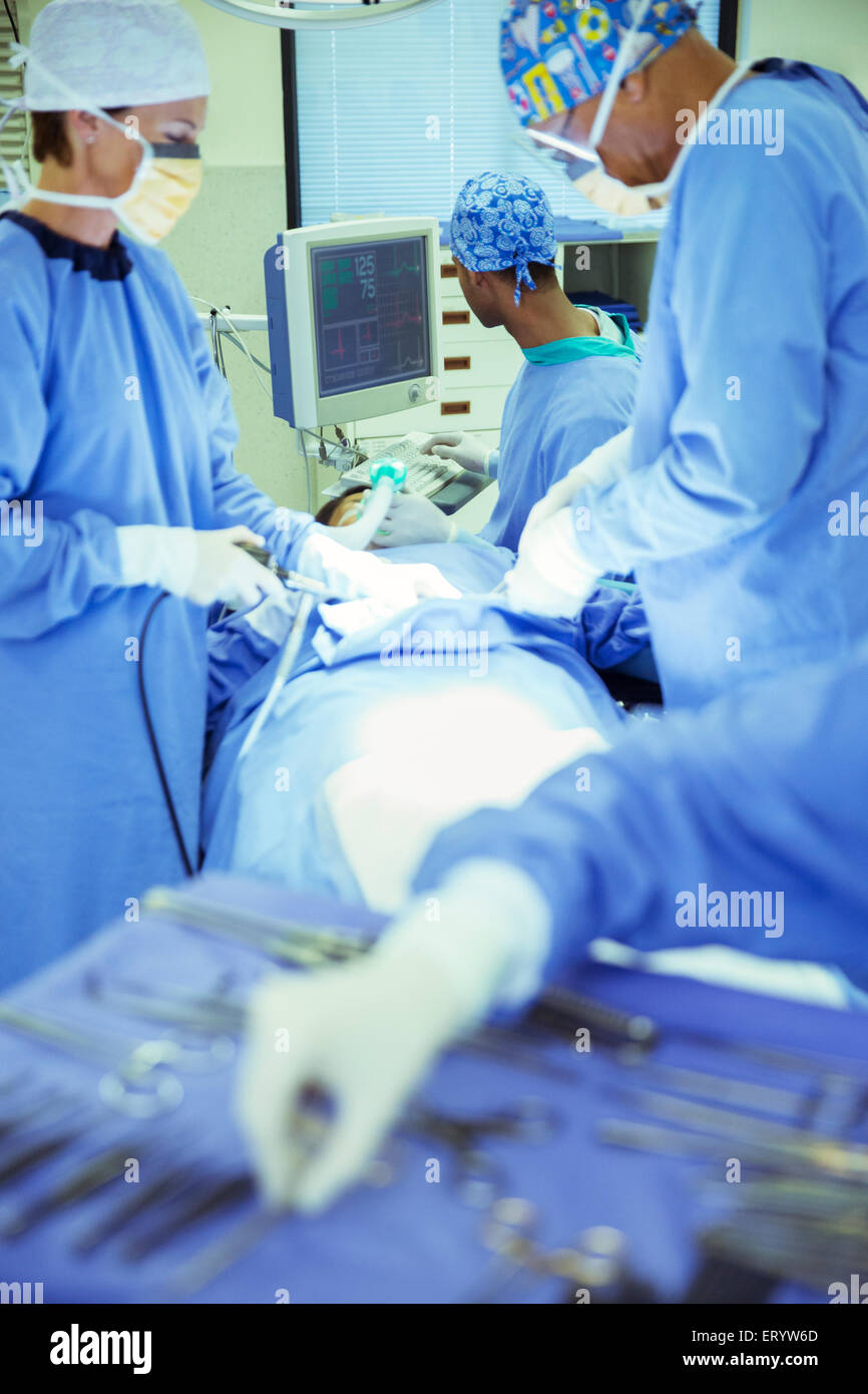 Surgeons performing surgery in operating room Stock Photo - Alamy