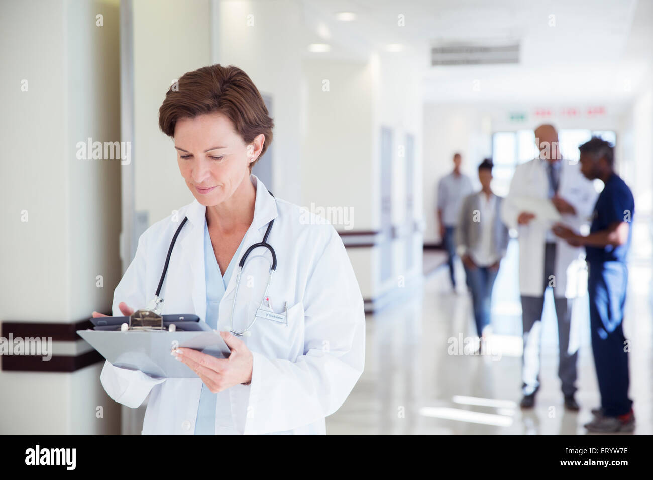 Doctor using digital tablet in hospital corridor Stock Photo - Alamy