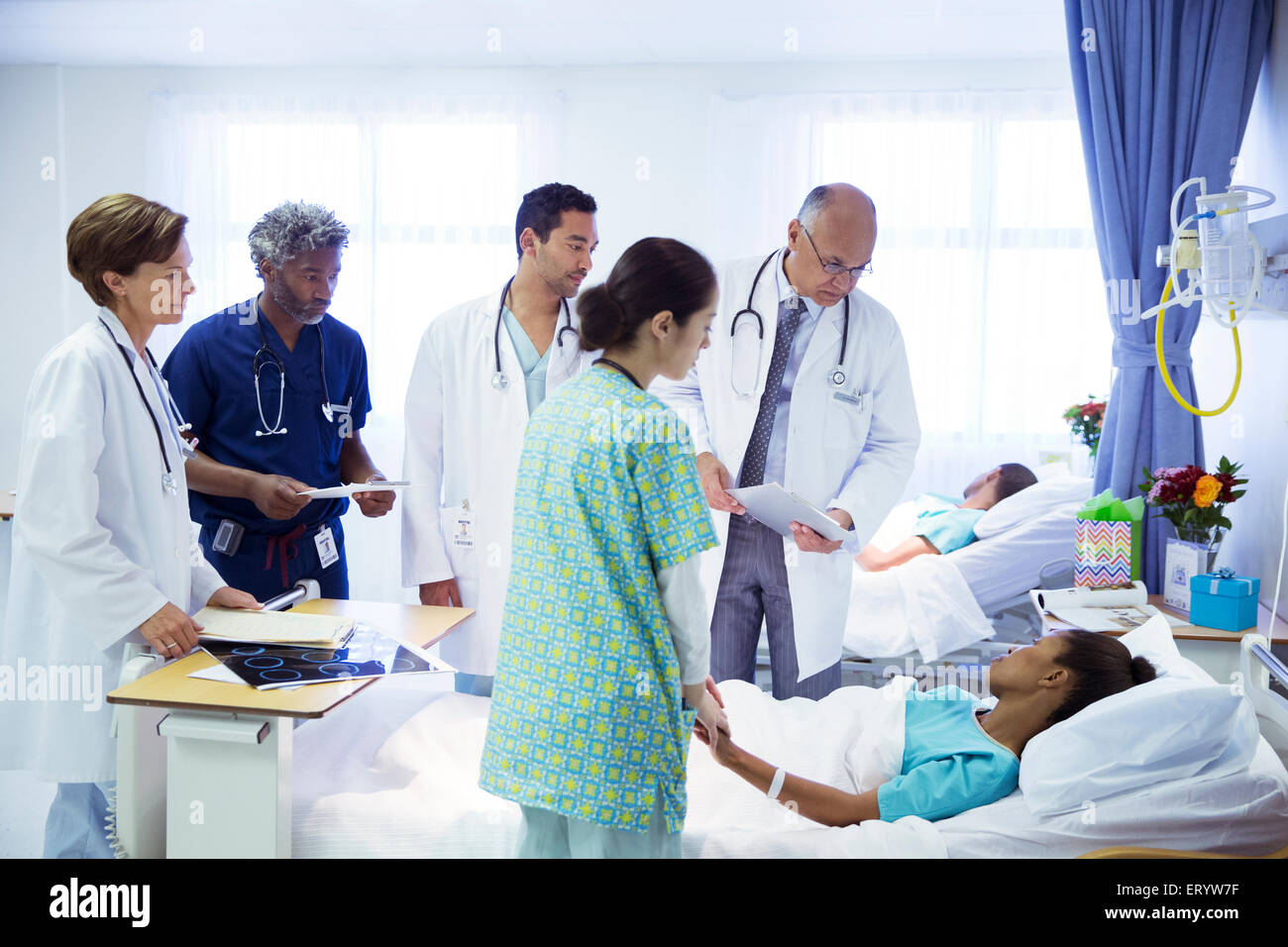Doctors and nurse making rounds in hospital room Stock Photo - Alamy
