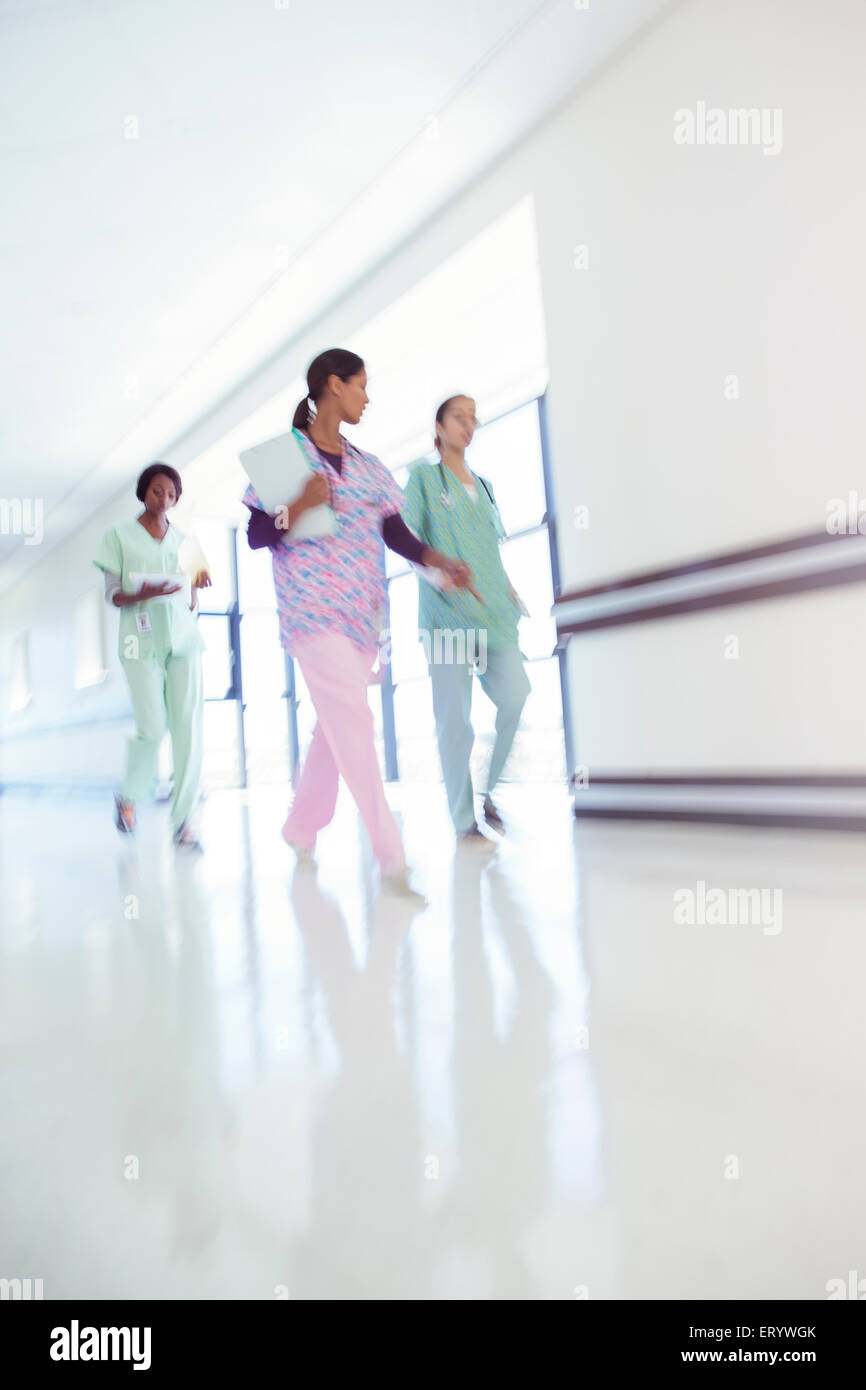Nurses walking in hospital corridor Stock Photo - Alamy